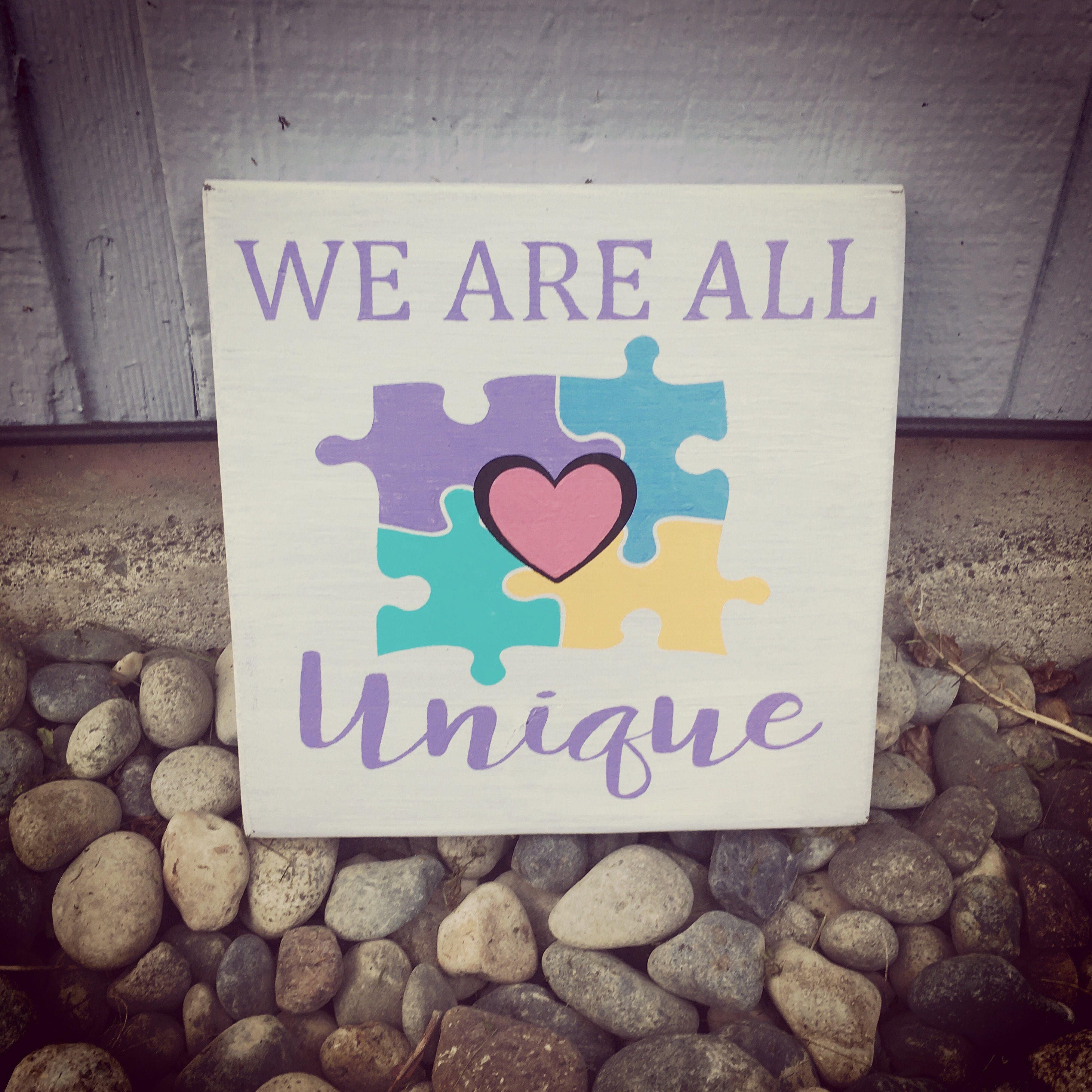 Autism Awareness puzzle pieces We are all unique hand