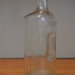 Vintage Gordon glass liquor bottle with yellow lid barware