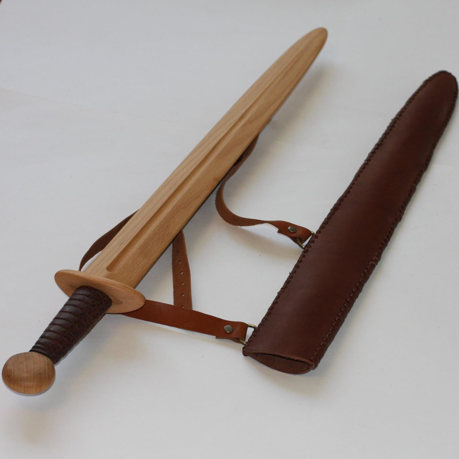 Toy wooden sword with leather sheath